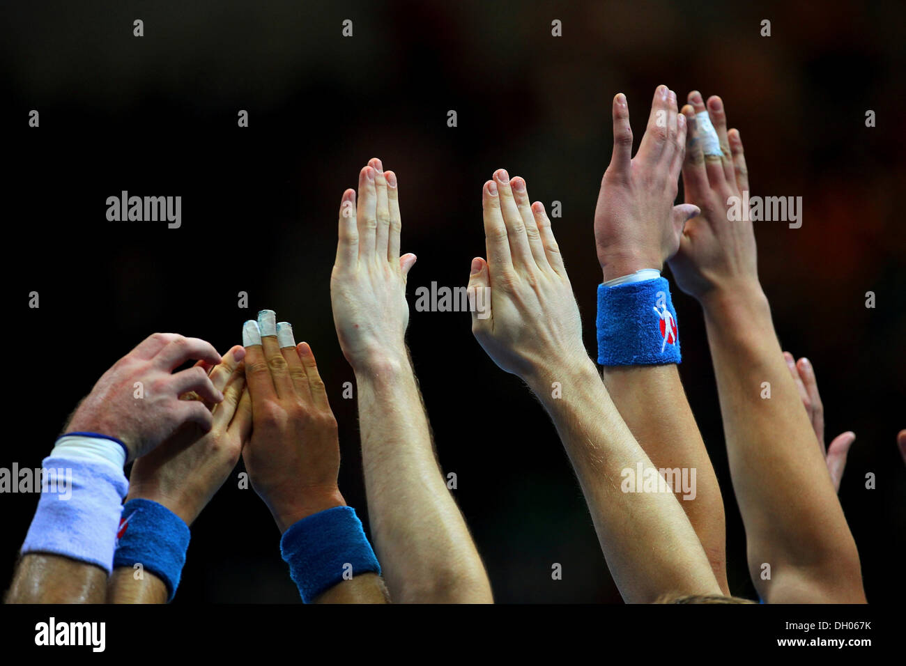 Handball players stretch their hands up to fend off a free-kick Stock ...