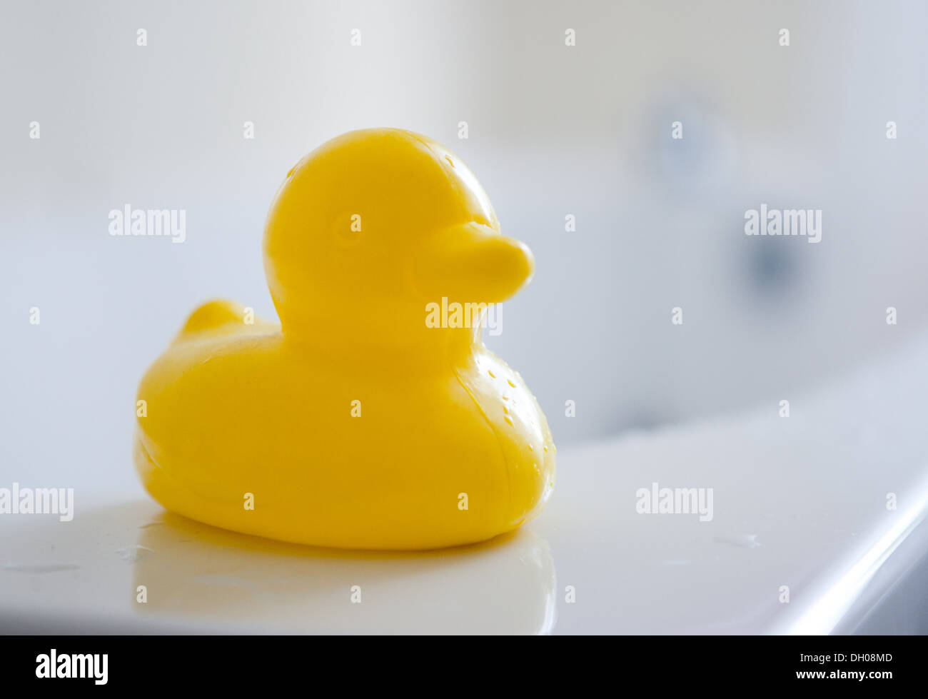 yellow rubber duck on side of bath Stock Photo - Alamy