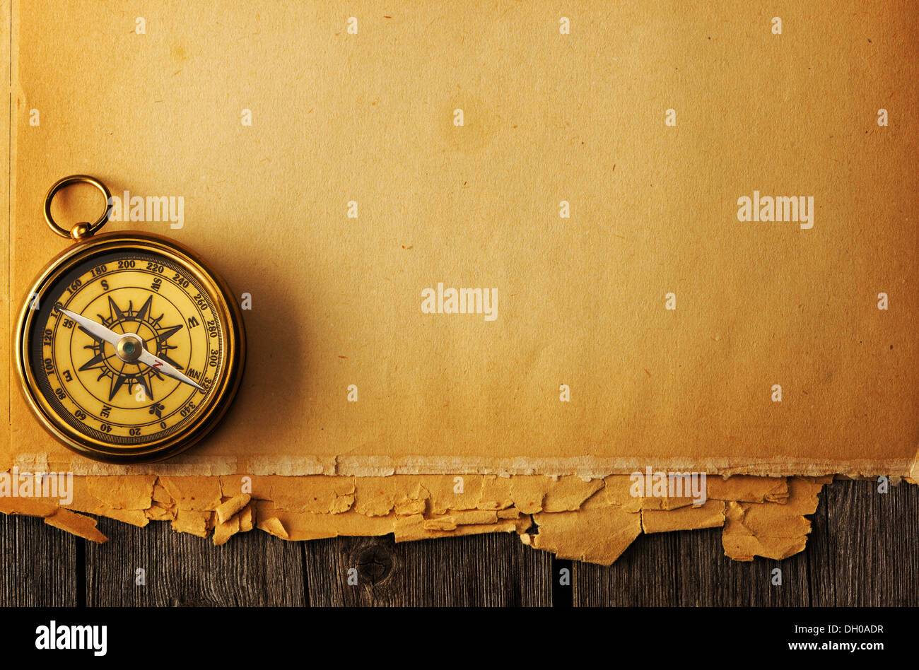 Antique brass compass over old background Stock Photo - Alamy