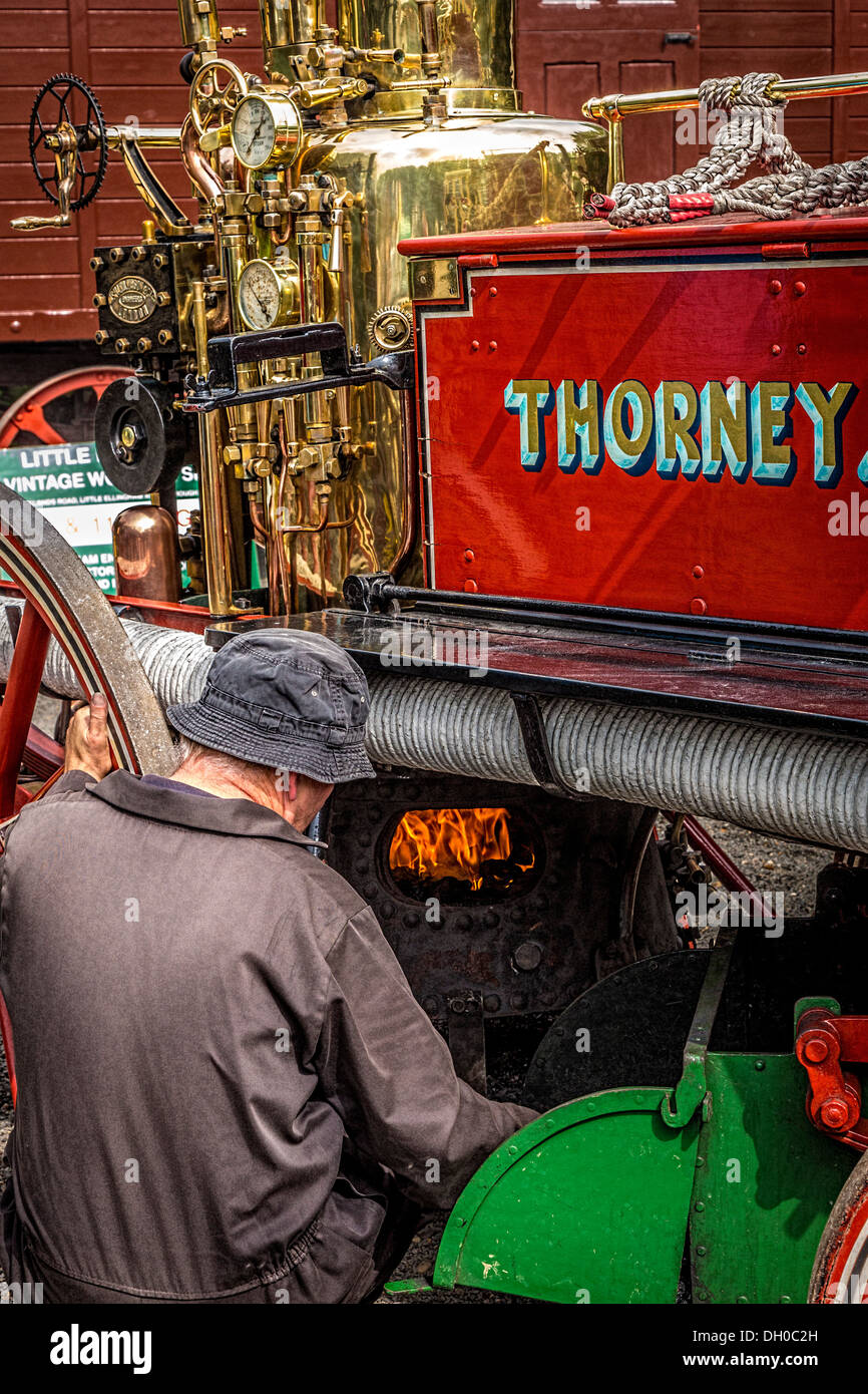 Stoking the fire on the1908 Shand Mason Horse Drawn Steam Fire Engine ...