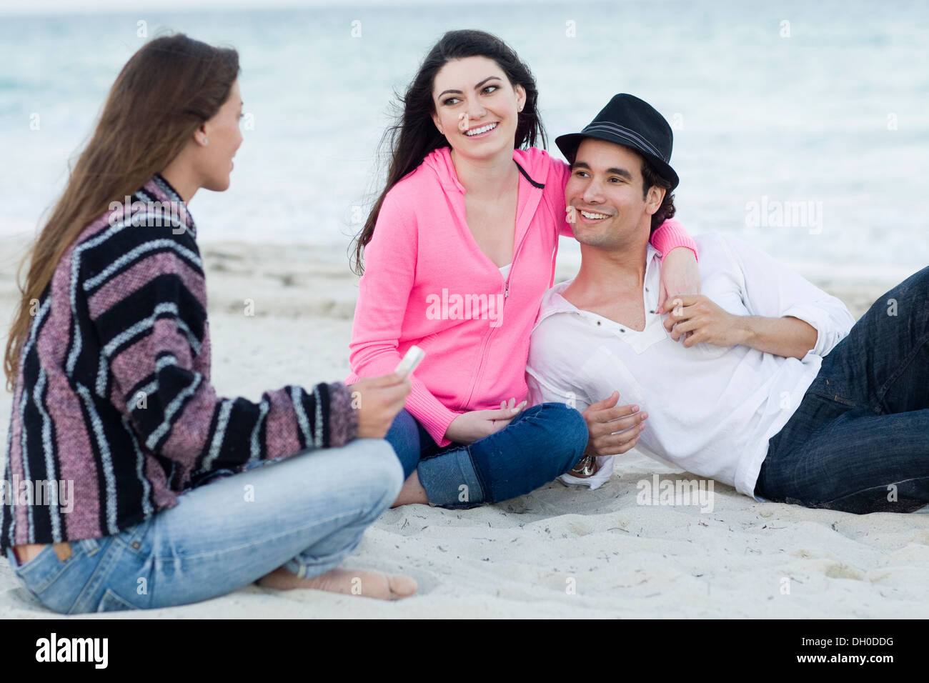 Friends relaxing together on beach Stock Photo - Alamy