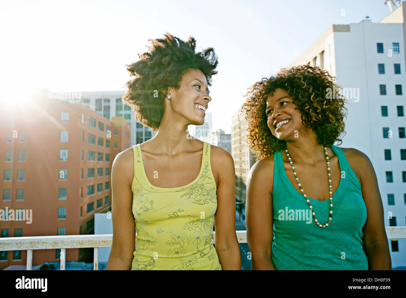 Mixed race women on urban rooftop Stock Photo - Alamy