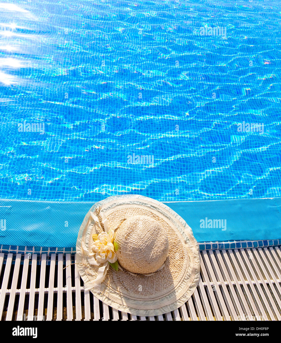 The straw hat lie near pool Stock Photo - Alamy