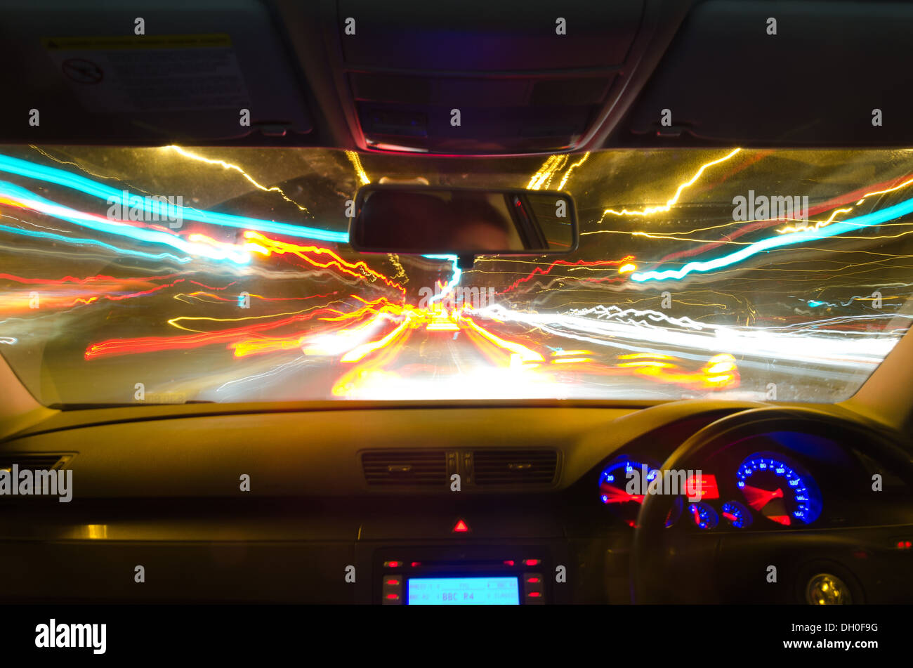 view through the windscreen of a moving car with motion blur and ...