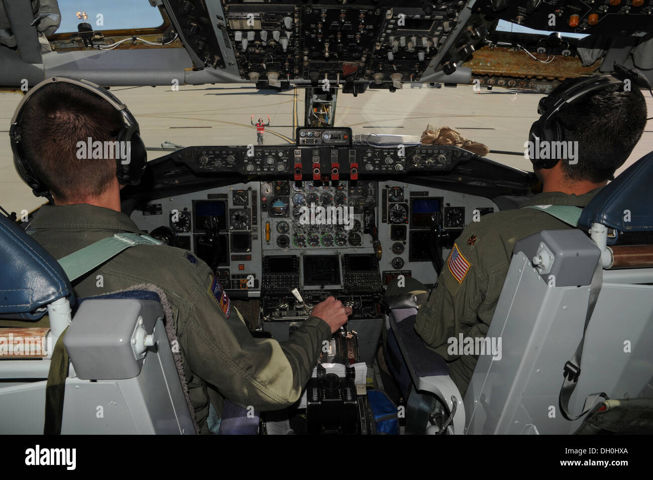 Pilots from the 384th Air Refueling Squadron are marshaled into ...