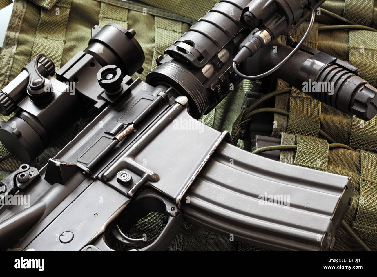 Detail of a scratched M4A1 (AR-15) carbine and green military tactical ...