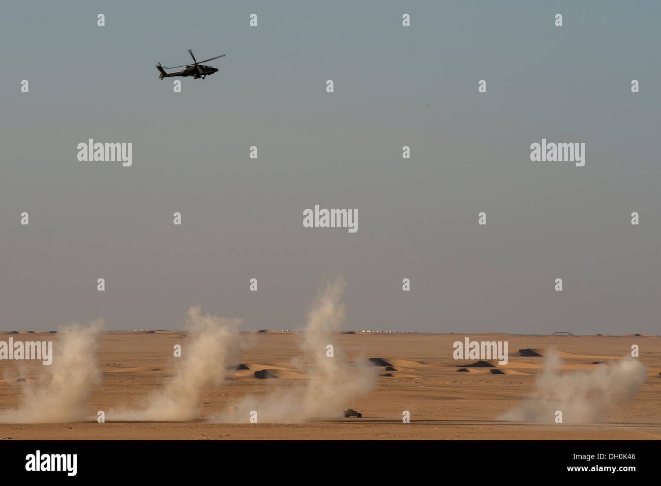 A U.S Army AH-64 Apache helicopter from the 36th Aviation Brigade banks ...