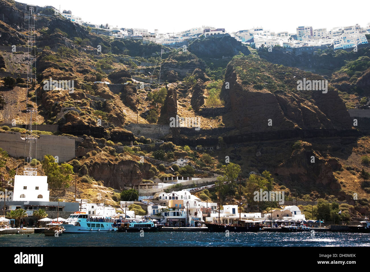 Skala Pier, the Old Port of Santorini, seen from the water sailing ...