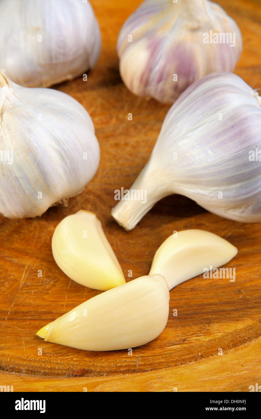 garlic cloves and buds on a wooden plate Stock Photo - Alamy