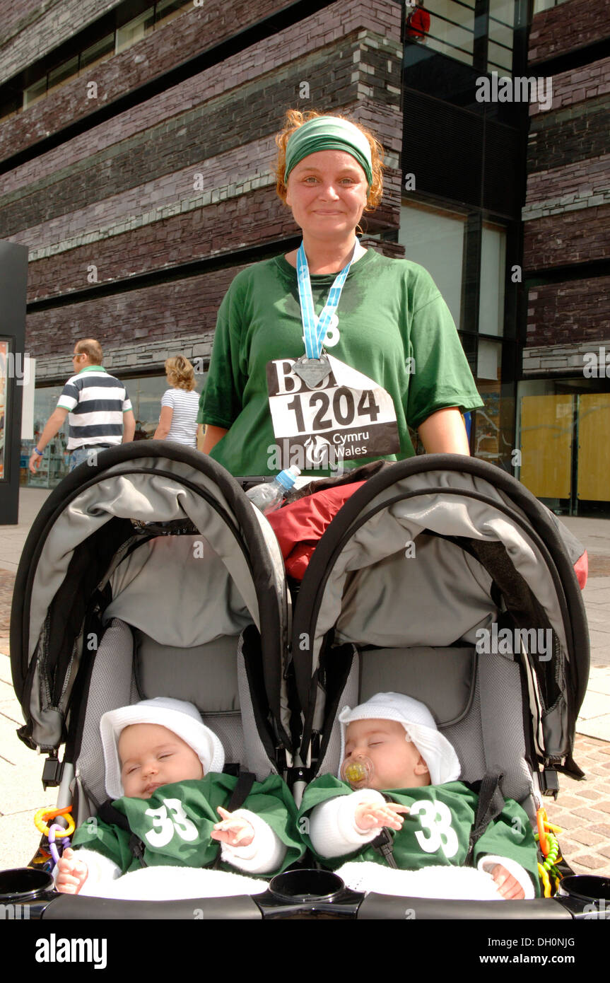 An athlete with her two baby's in a pushchair photographed before ...