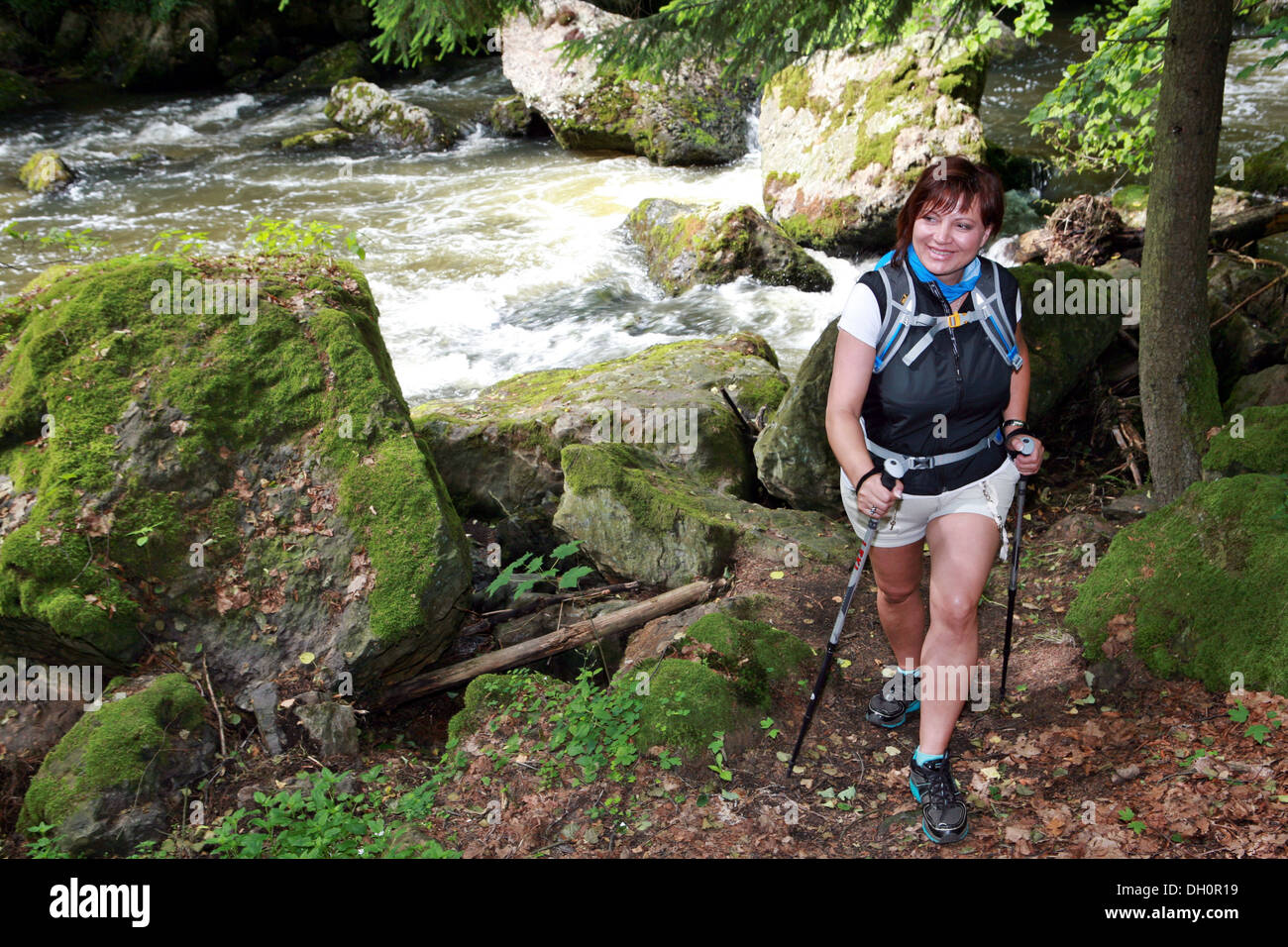 female walker with hiking sticks Stock Photo - Alamy