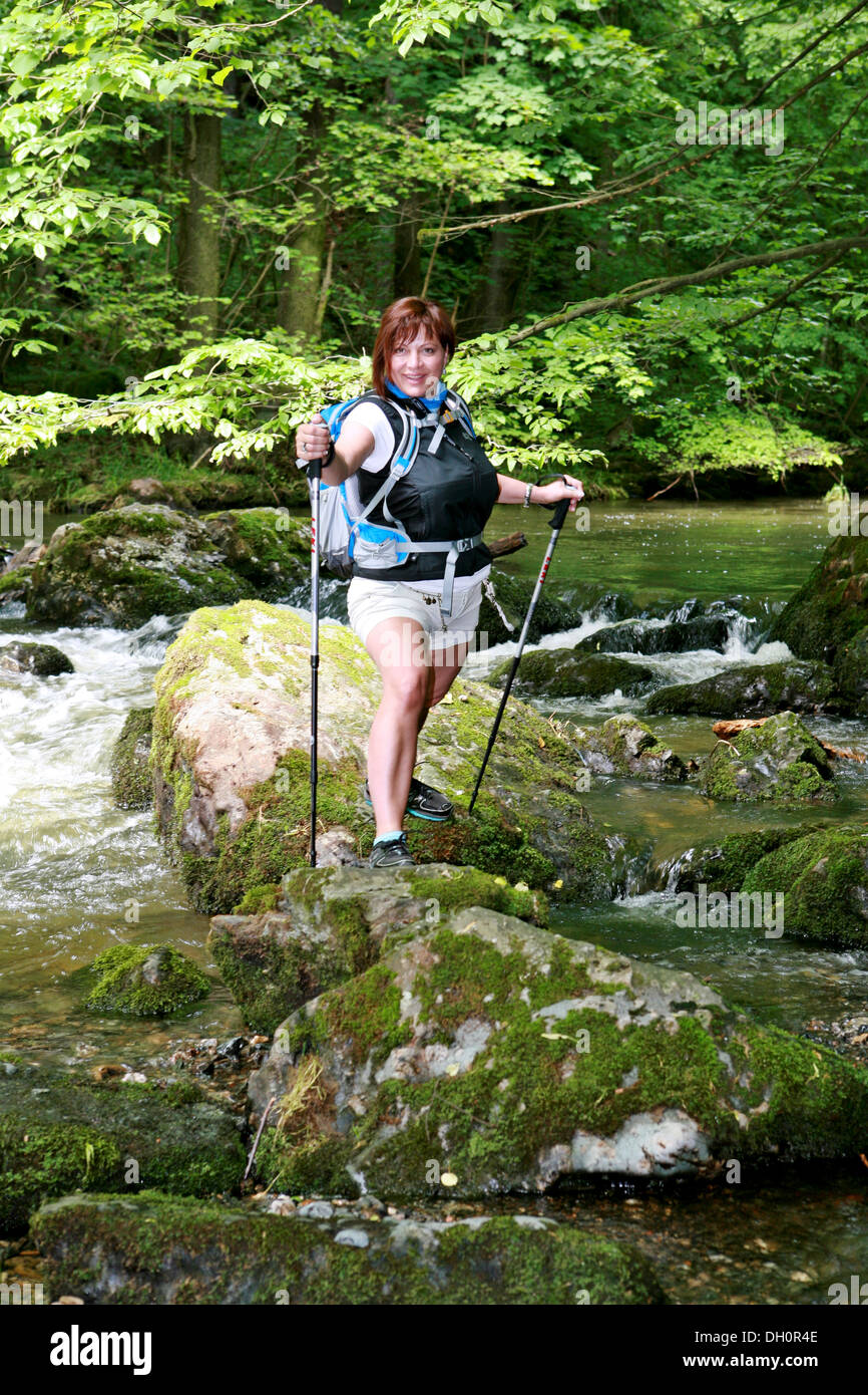 female walker with hiking sticks Stock Photo - Alamy