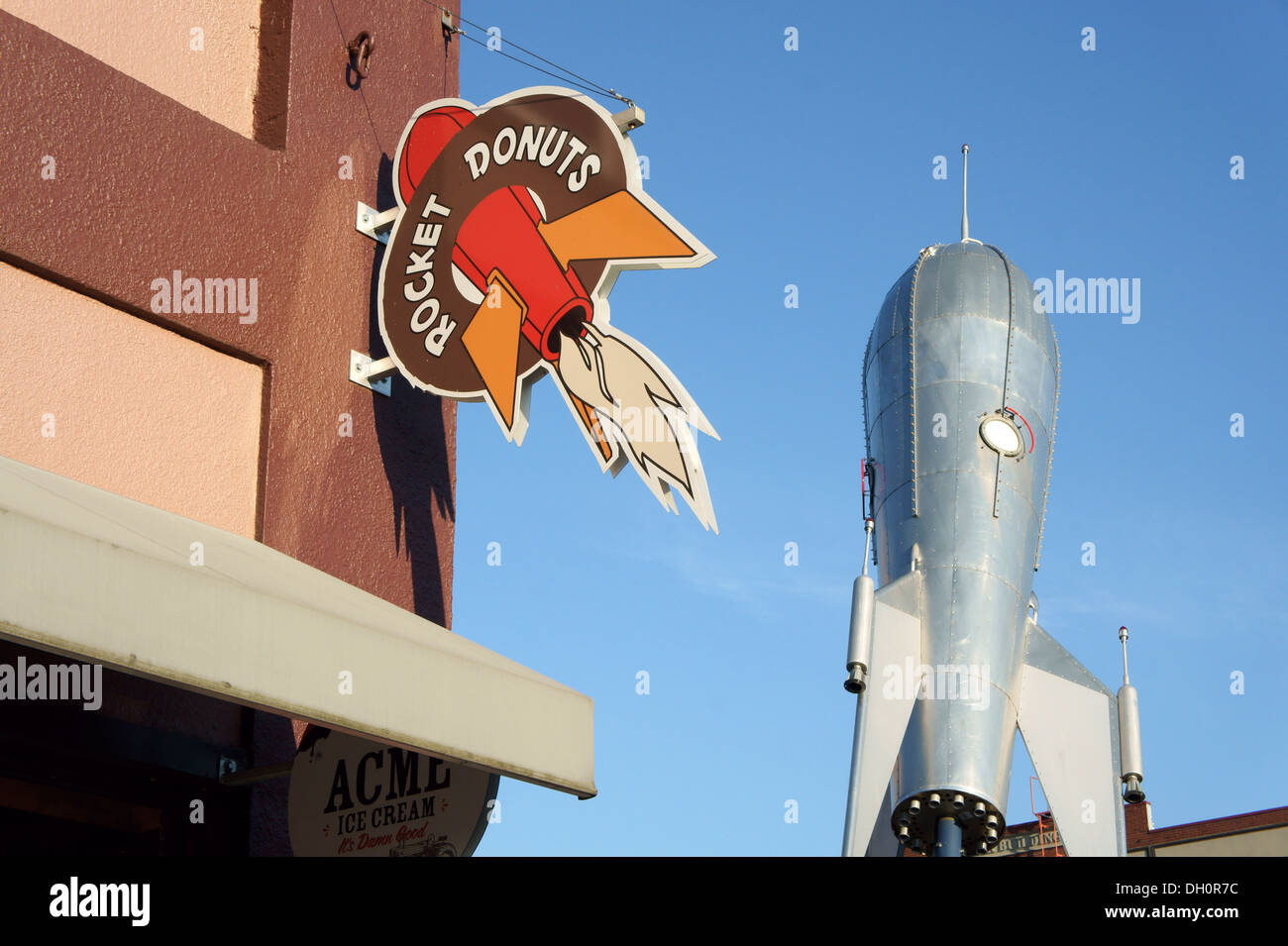 Rocket Donuts shop sign and metal rocket sculpture and in the city of ...