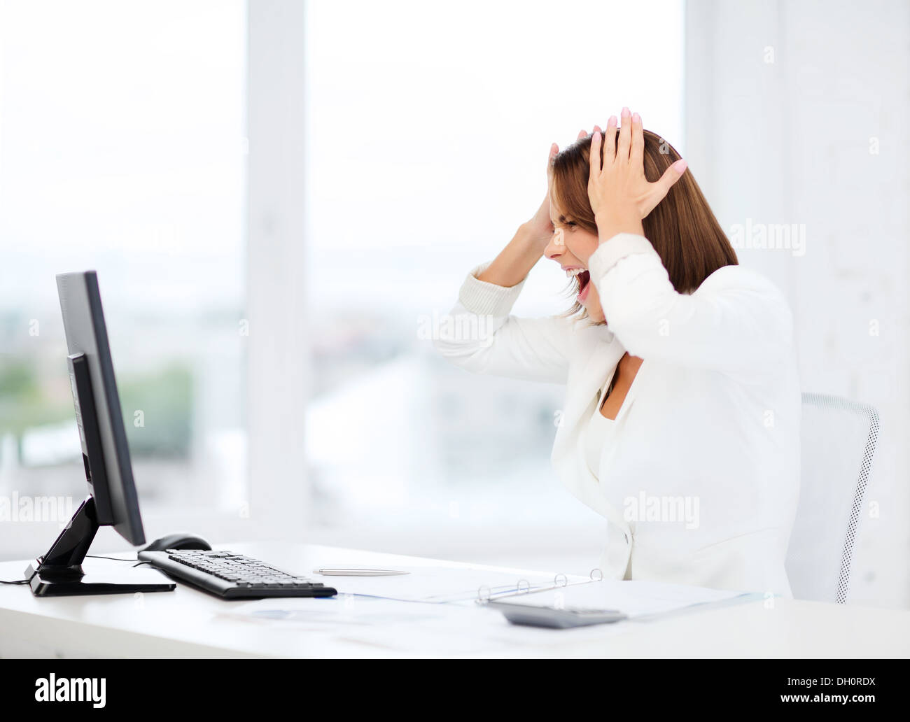 stressed woman with computer Stock Photo - Alamy