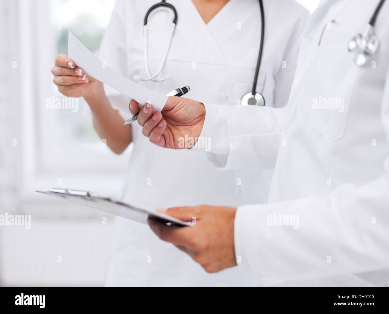 two doctors writing prescription Stock Photo - Alamy