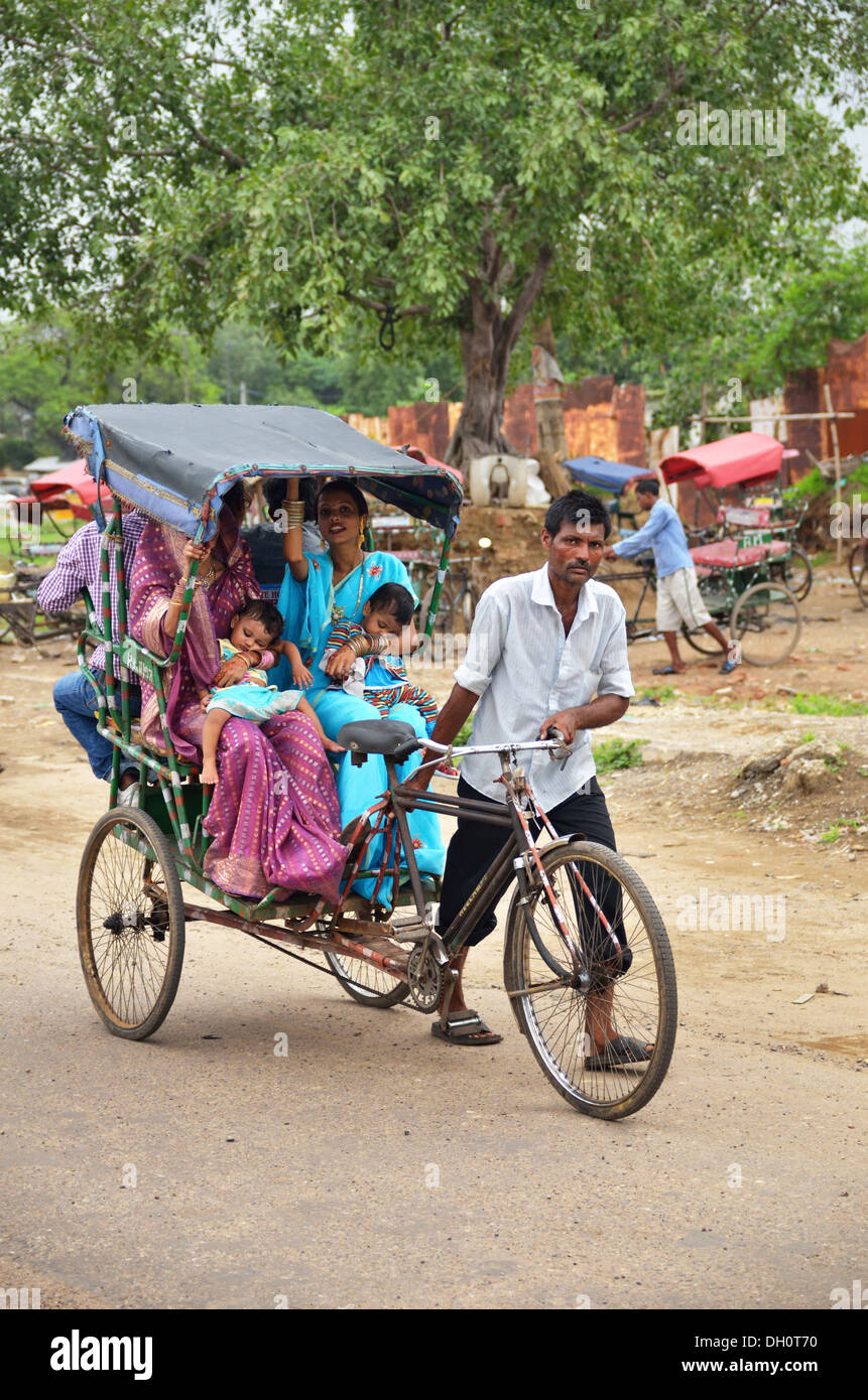 Mothers and their children on a rickshaw ride through the streets of ...
