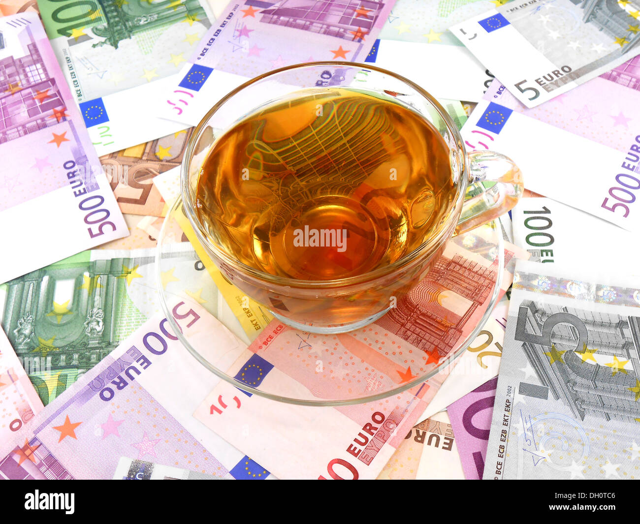 tea or coffee cup on money wallpaper Stock Photo - Alamy