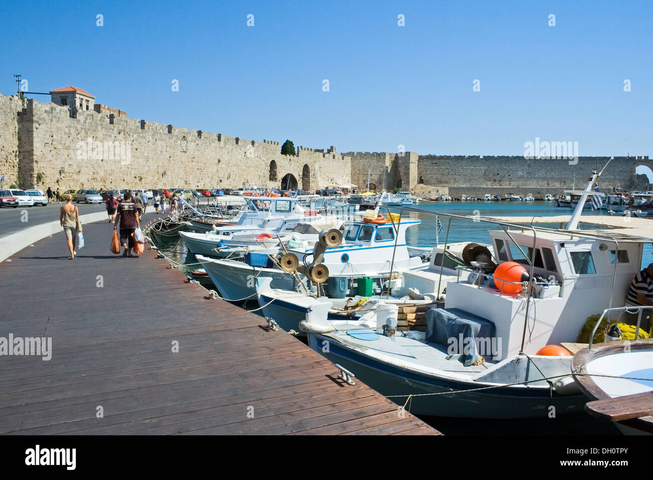 View of Rhodes harbour, Greece. Motor boats and the ancient city wall ...
