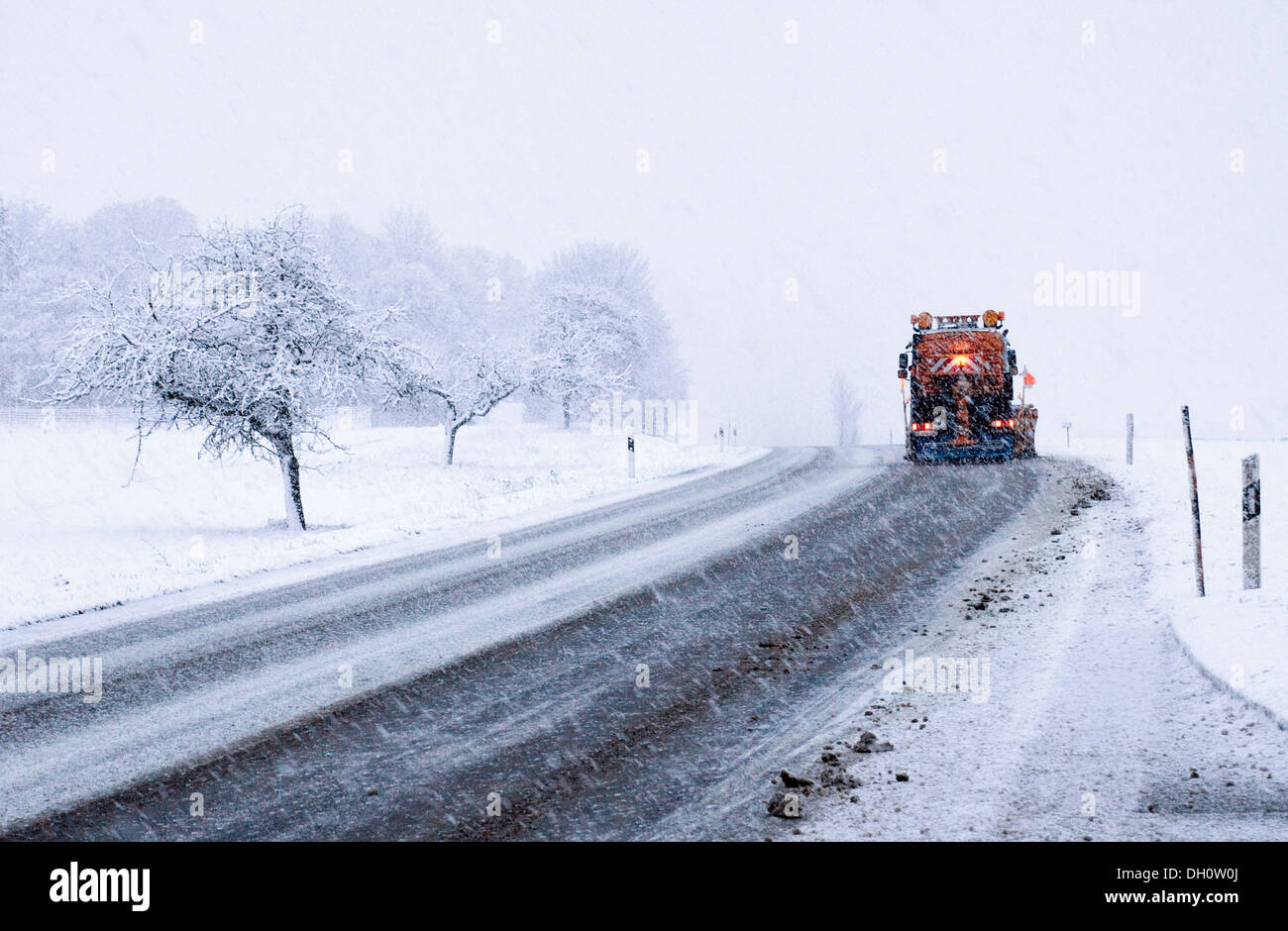 Snow-clearing vehicle clearing snow during strong snowfall Stock Photo ...
