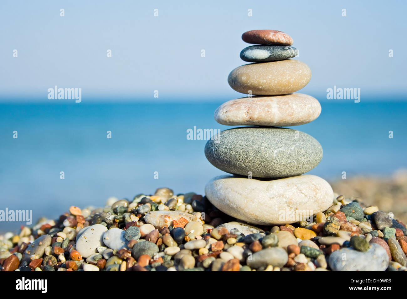 Differently sized and colored pebbles, stacked Stock Photo - Alamy