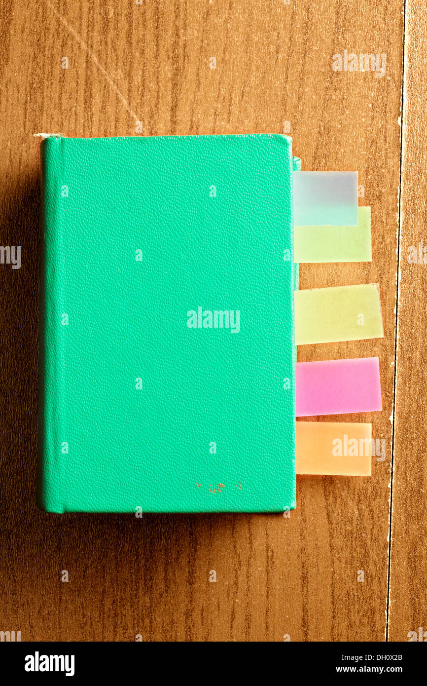 Green book with bookmarks Stock Photo - Alamy