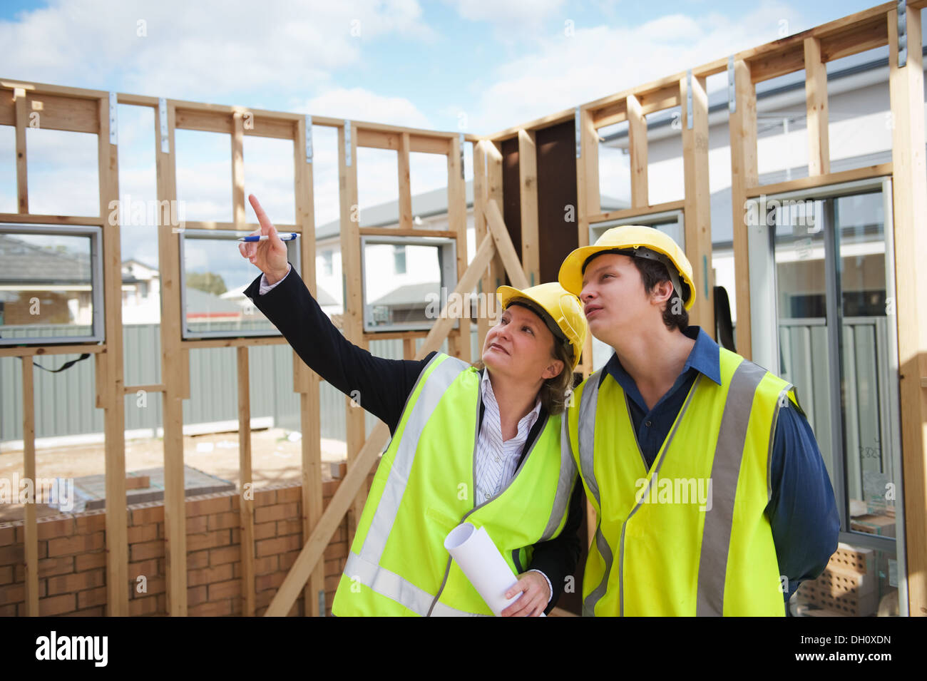 civil engineer and worker discussing issues at the construction site ...