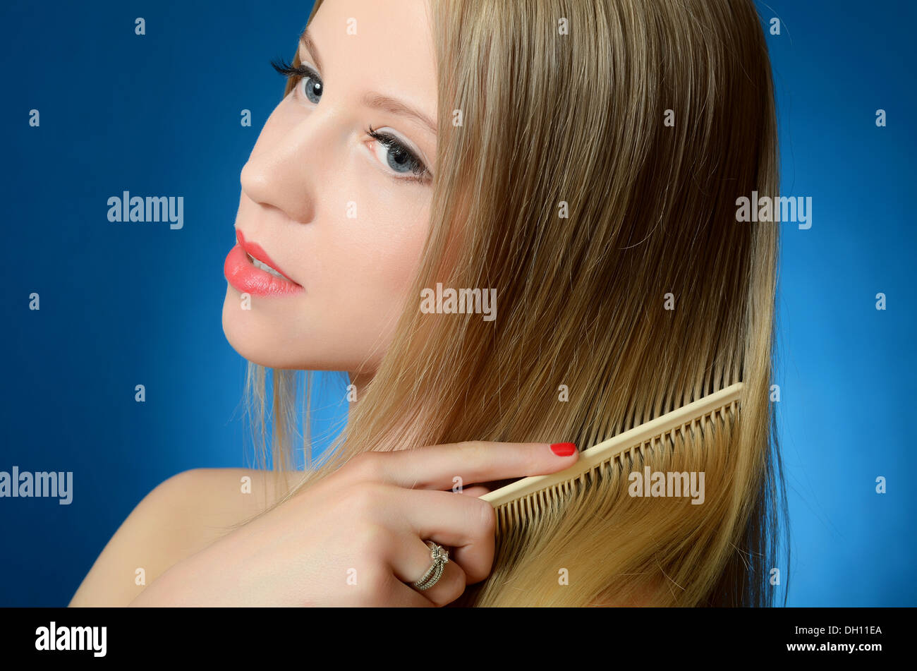 The beautiful girl brushes hair Stock Photo - Alamy