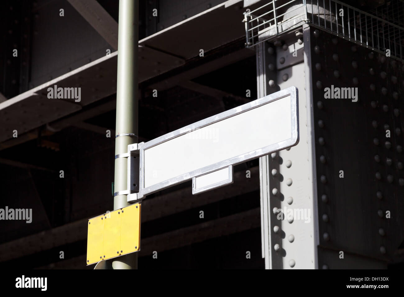 metal railroad bridge bearing and blank street pointer Stock Photo - Alamy