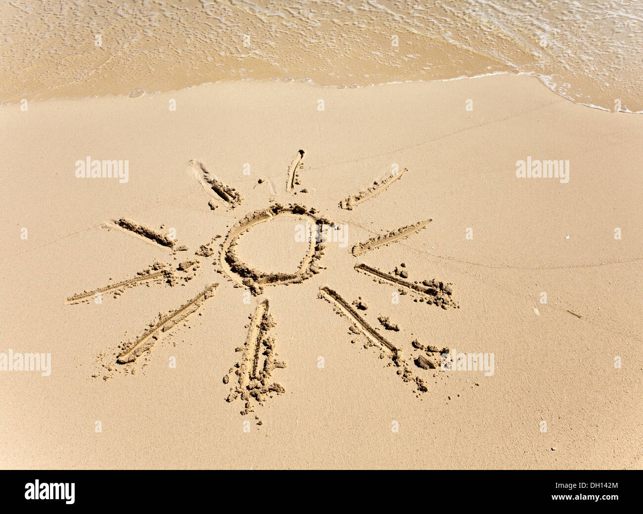 The sun - a picture on sand Stock Photo - Alamy