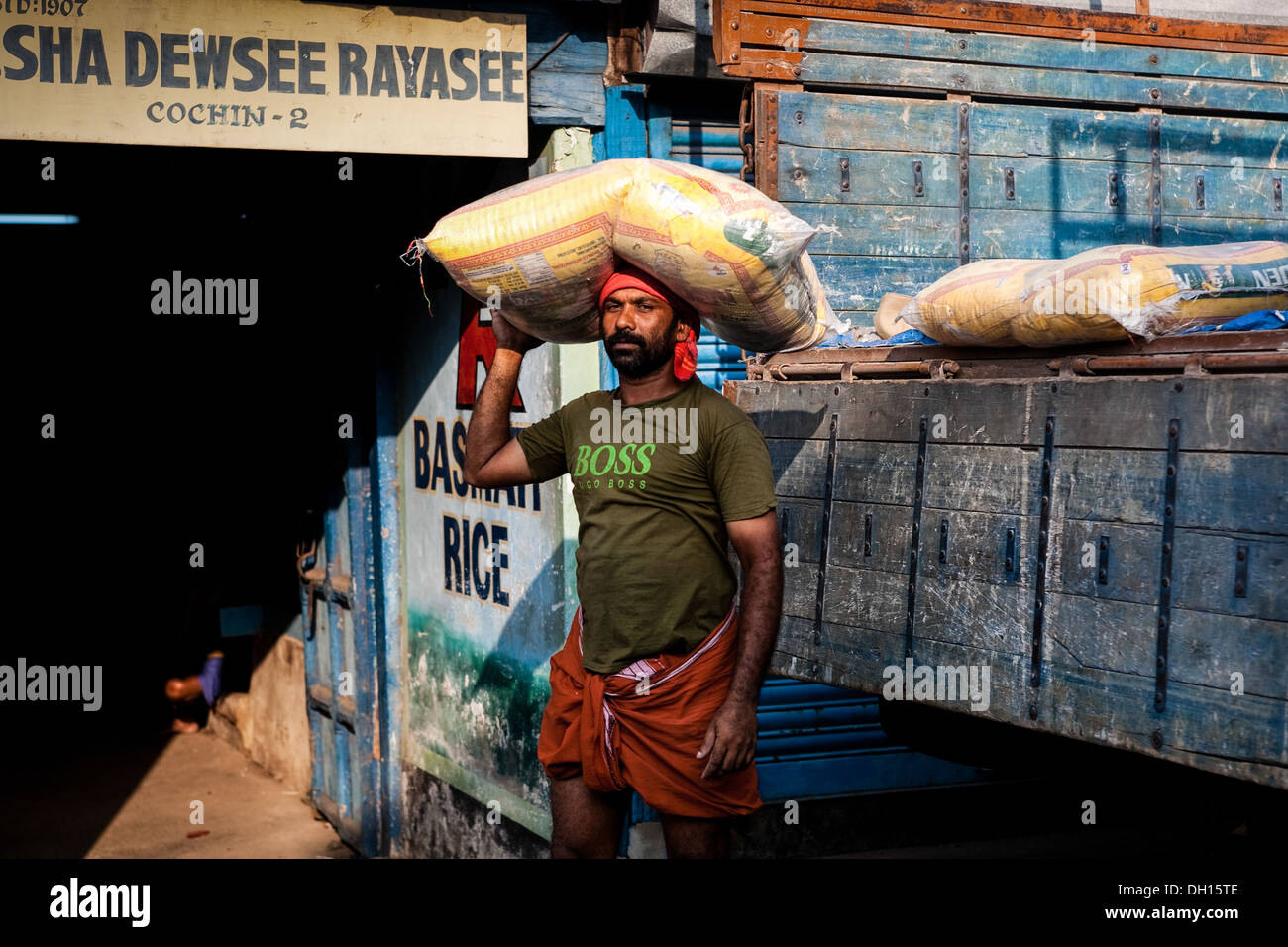 A man offloads sacks of rice in Spice Street Cochin India Stock Photo ...