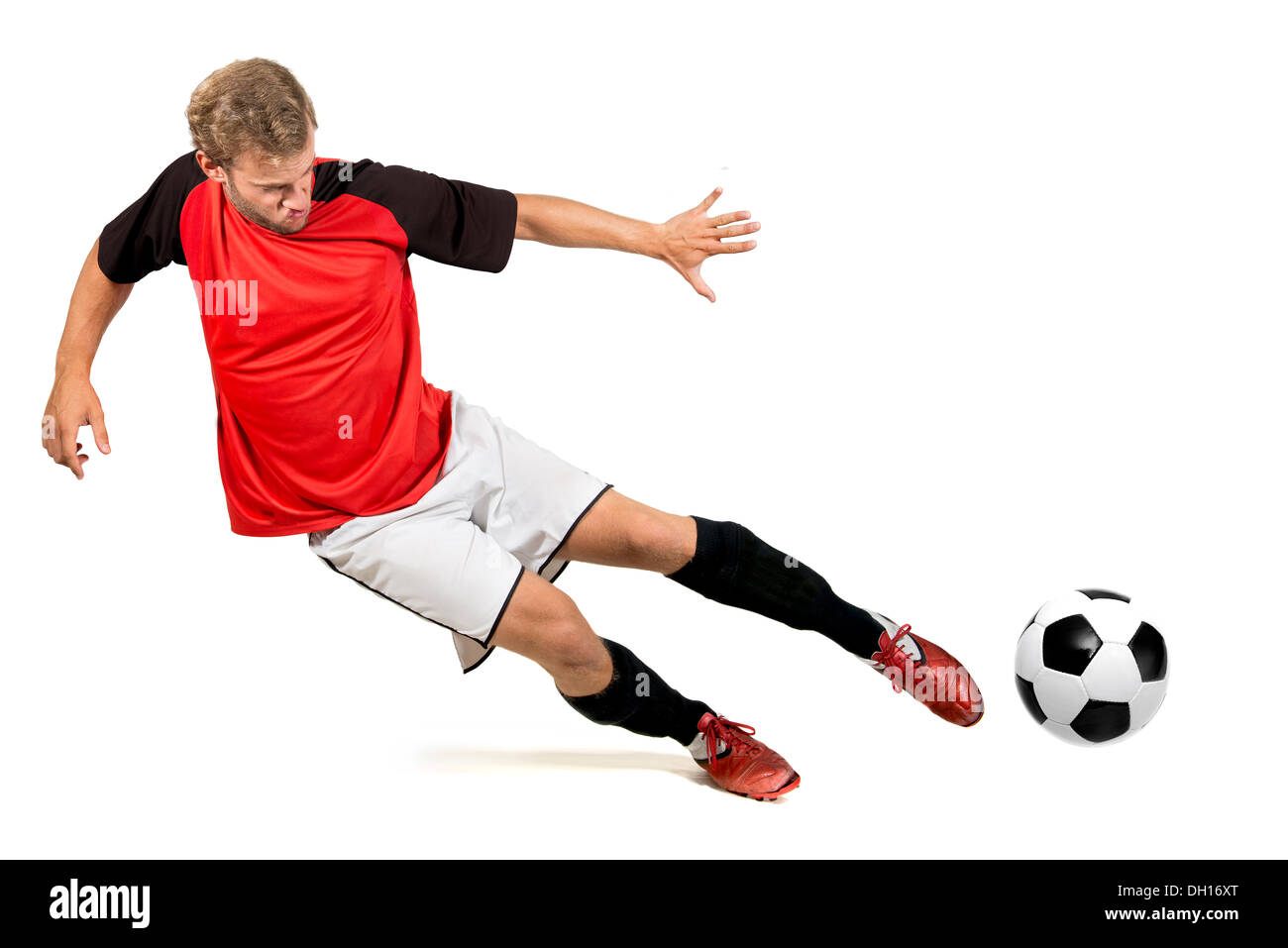 Football player kicking a ball isolated in white Stock Photo - Alamy