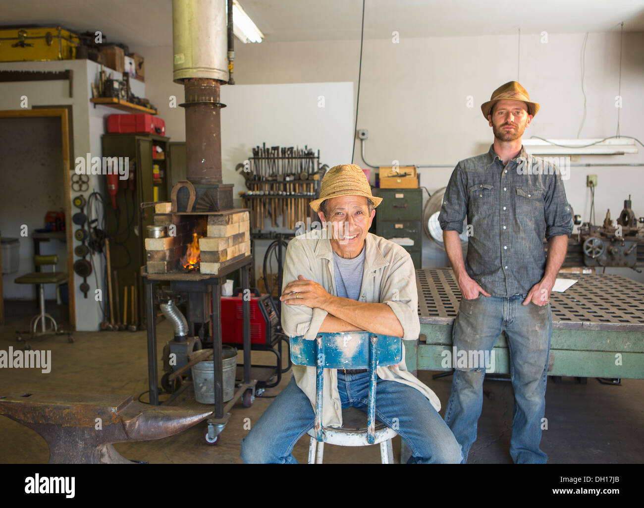 Man is sitting in front of his workshop hi-res stock photography and ...