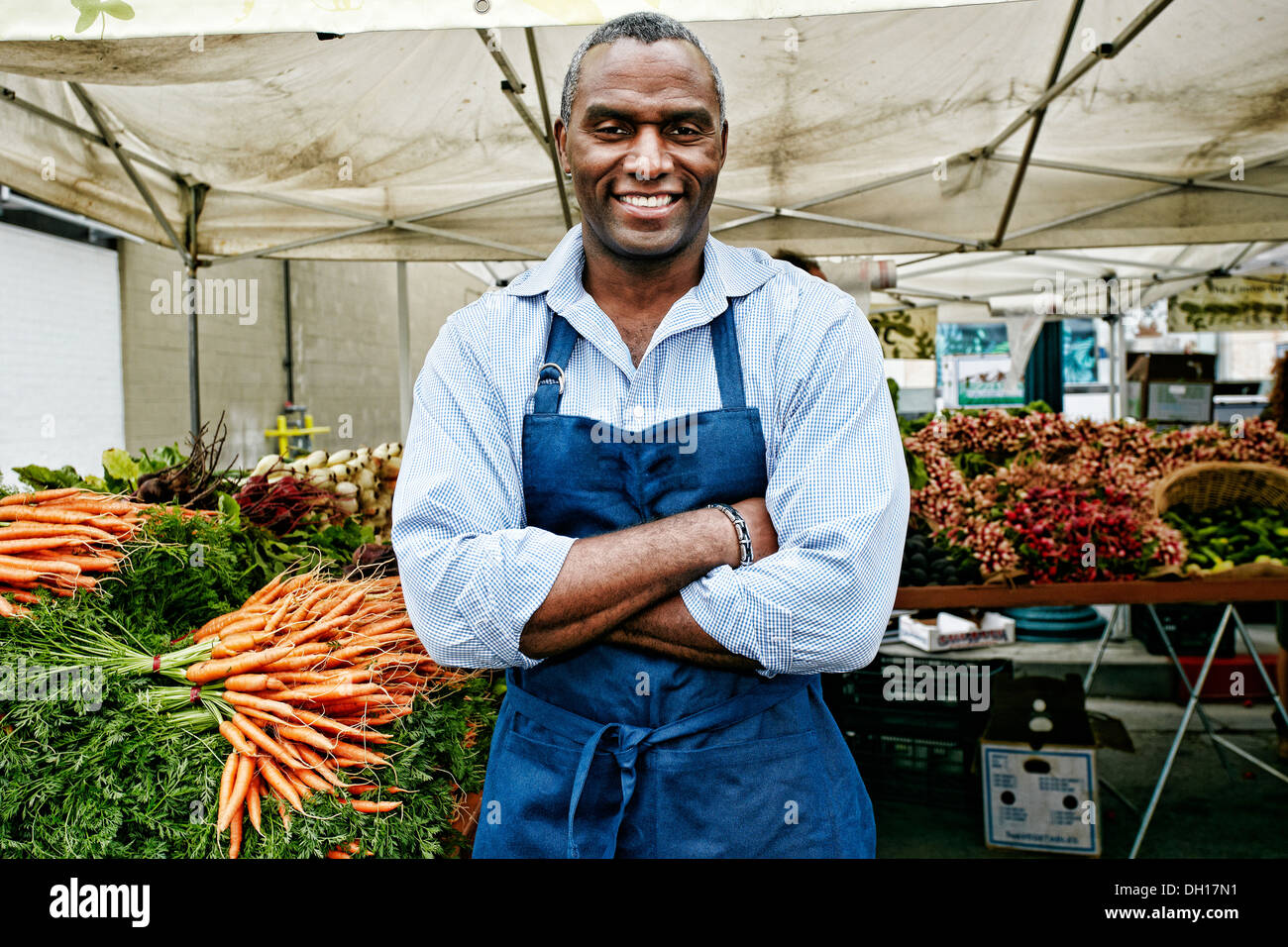 Black man working at outdoor market Stock Photo - Alamy