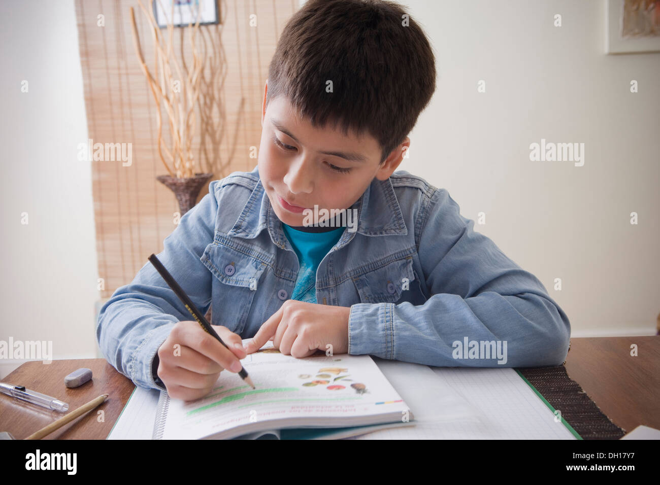 Boy doing homework with color pencil hi-res stock photography and ...