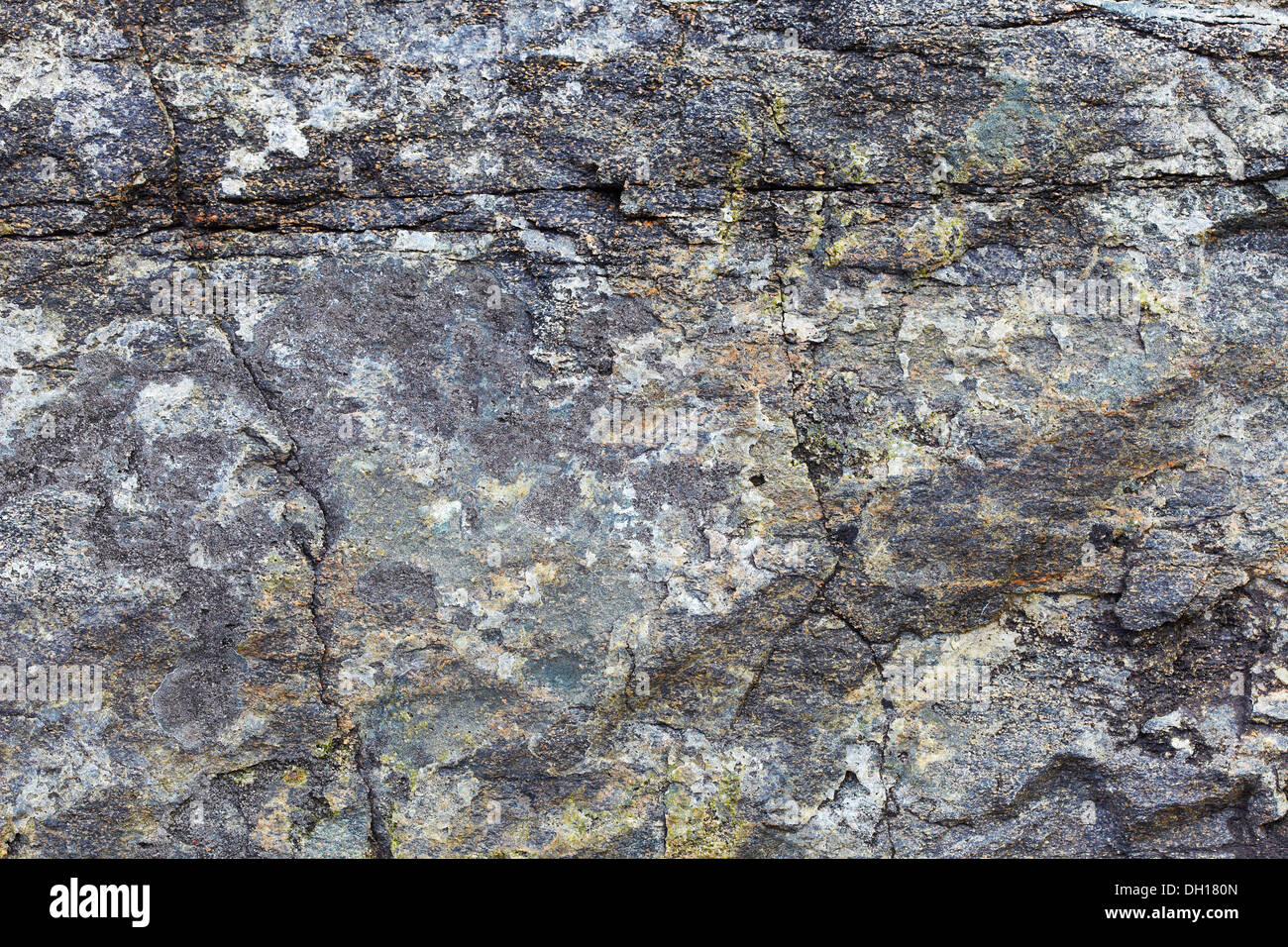 The surface of the granite rock with stains and cracks - a natural ...
