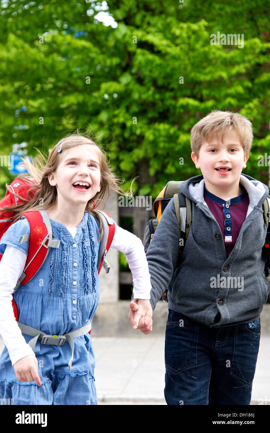Two children holding hands school hi-res stock photography and images ...