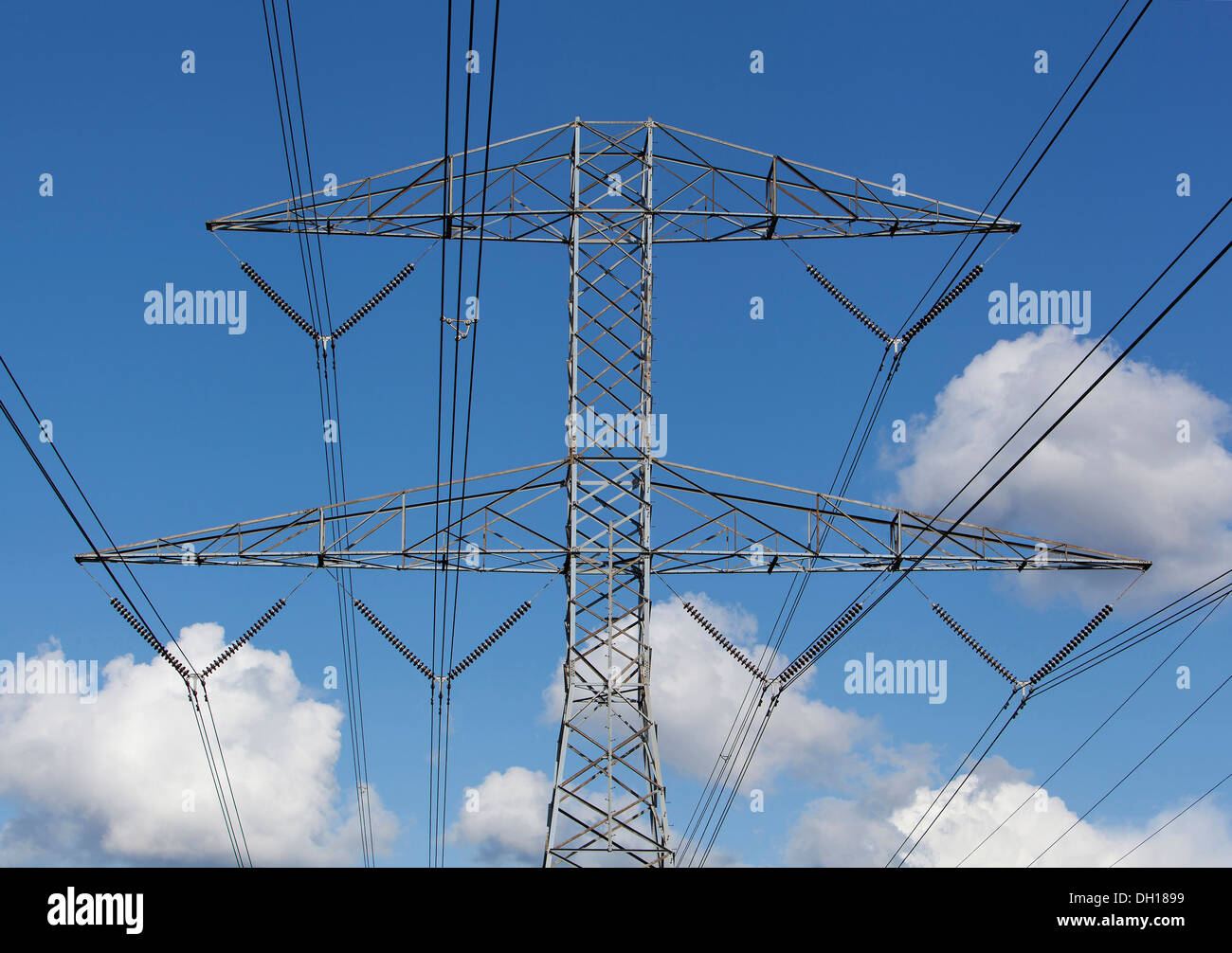Power lines against blue sky Stock Photo - Alamy