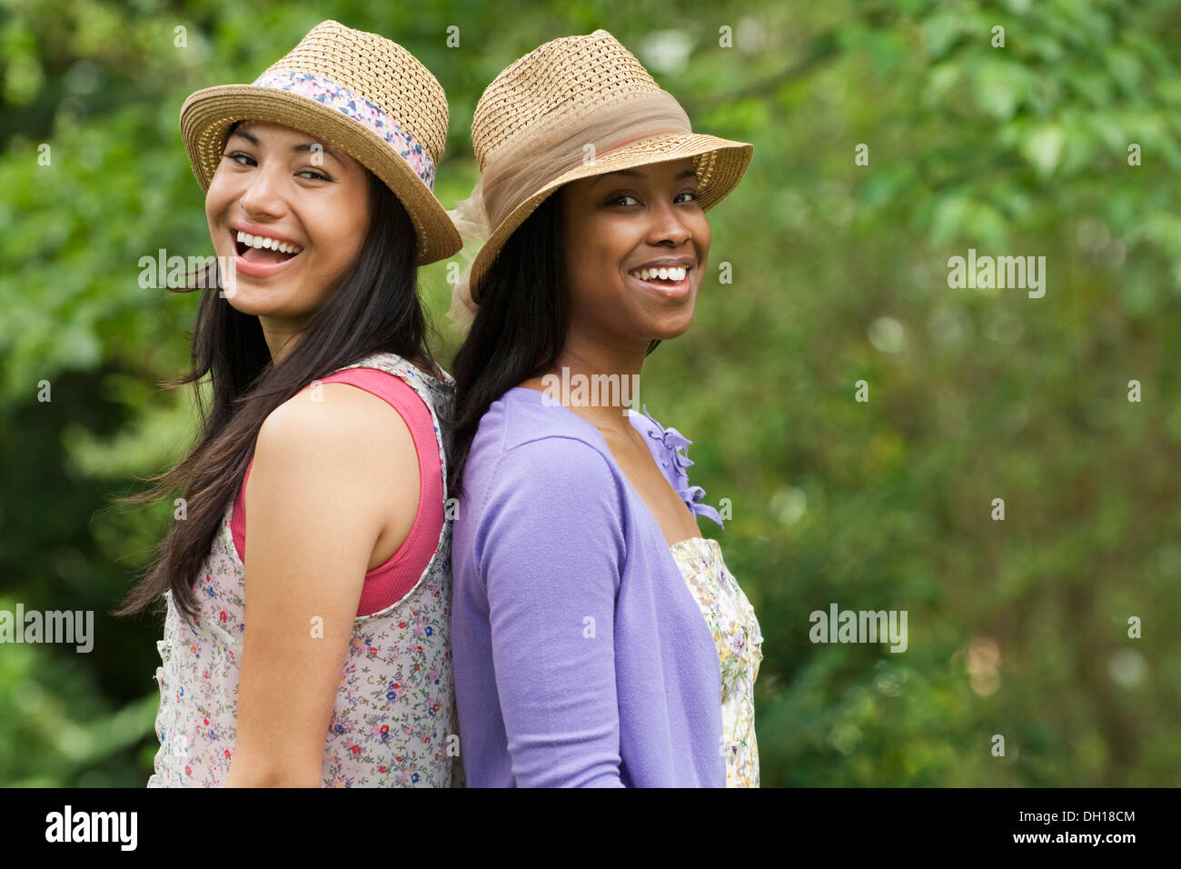 Women standing back to back outdoors Stock Photo - Alamy