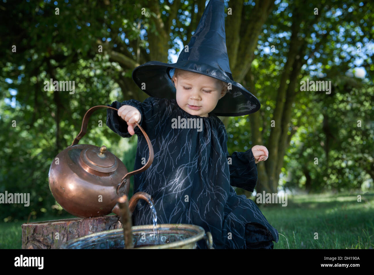 Little halloween witch , boiling a potion, outdoors in the woods Stock ...