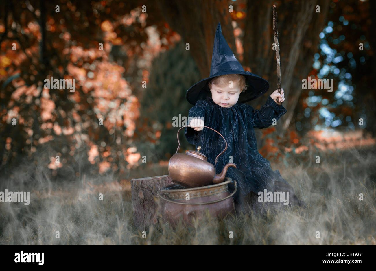 Little halloween witch , boiling a potion, outdoors in the woods Stock ...