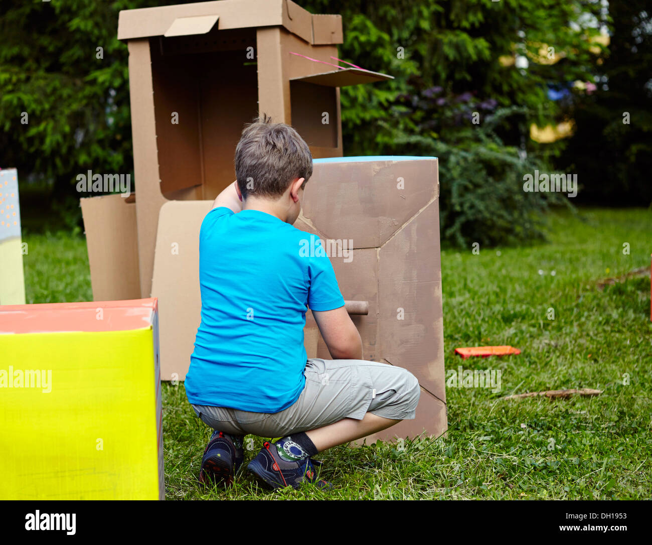 Boy painting cardboard box, Munich, Bavaria, Germany Stock Photo - Alamy