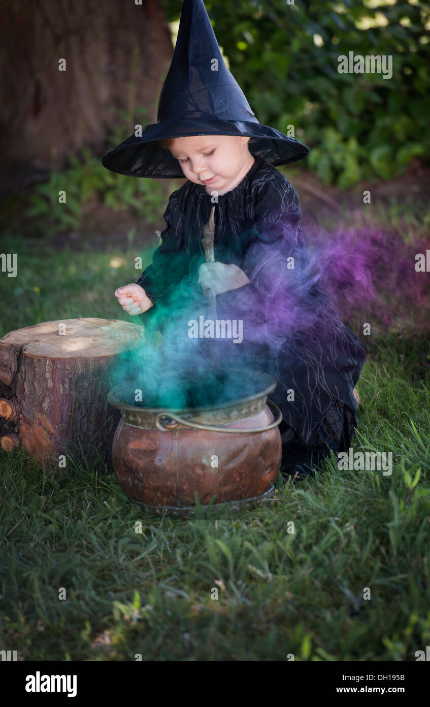 Little halloween witch , boiling a potion, outdoors in the woods Stock ...