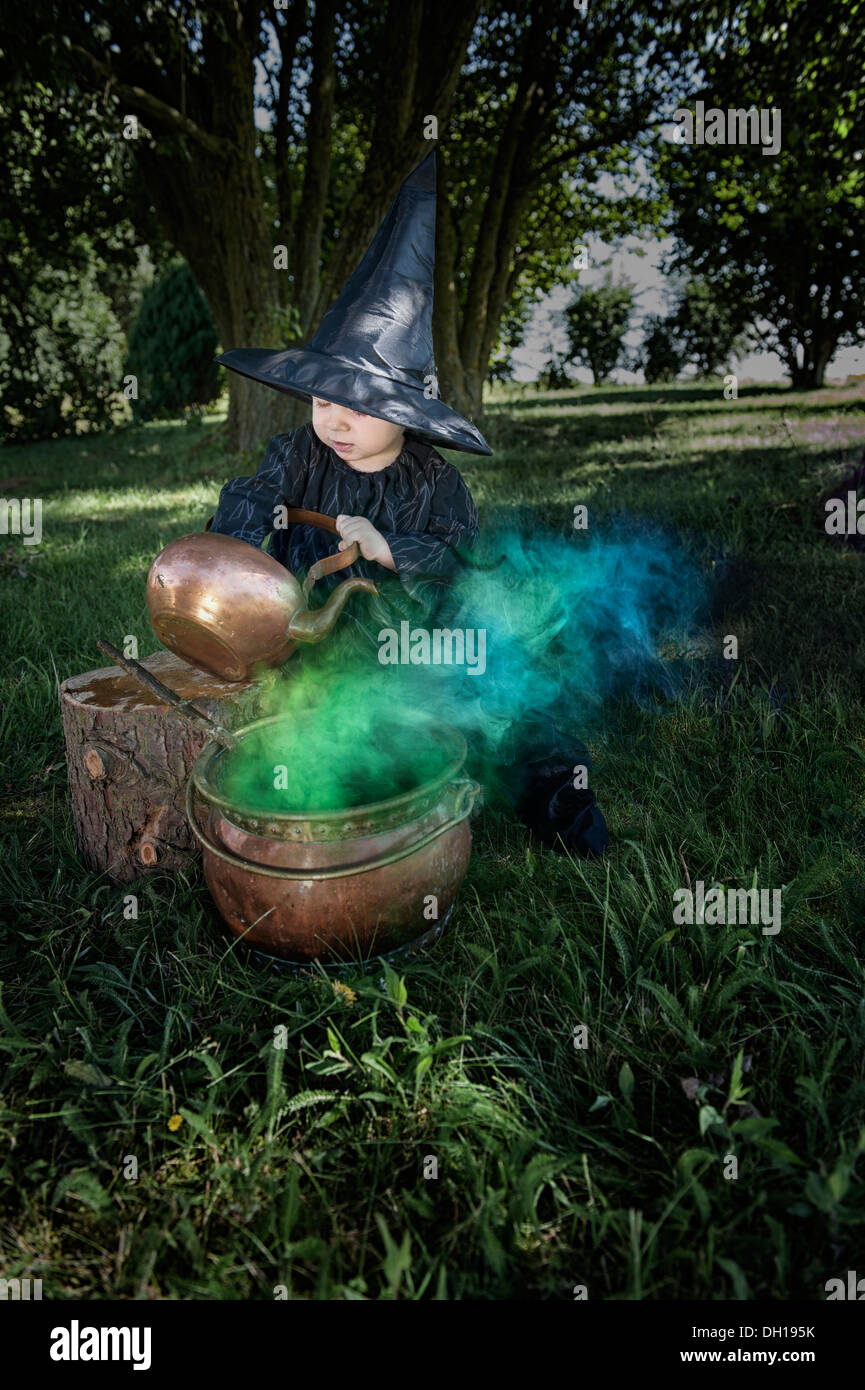 Little halloween witch , boiling a potion, outdoors in the woods Stock ...