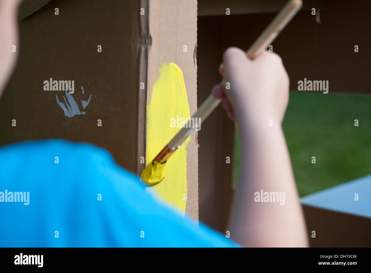 Boy painting cardboard box, Munich, Bavaria, Germany Stock Photo - Alamy