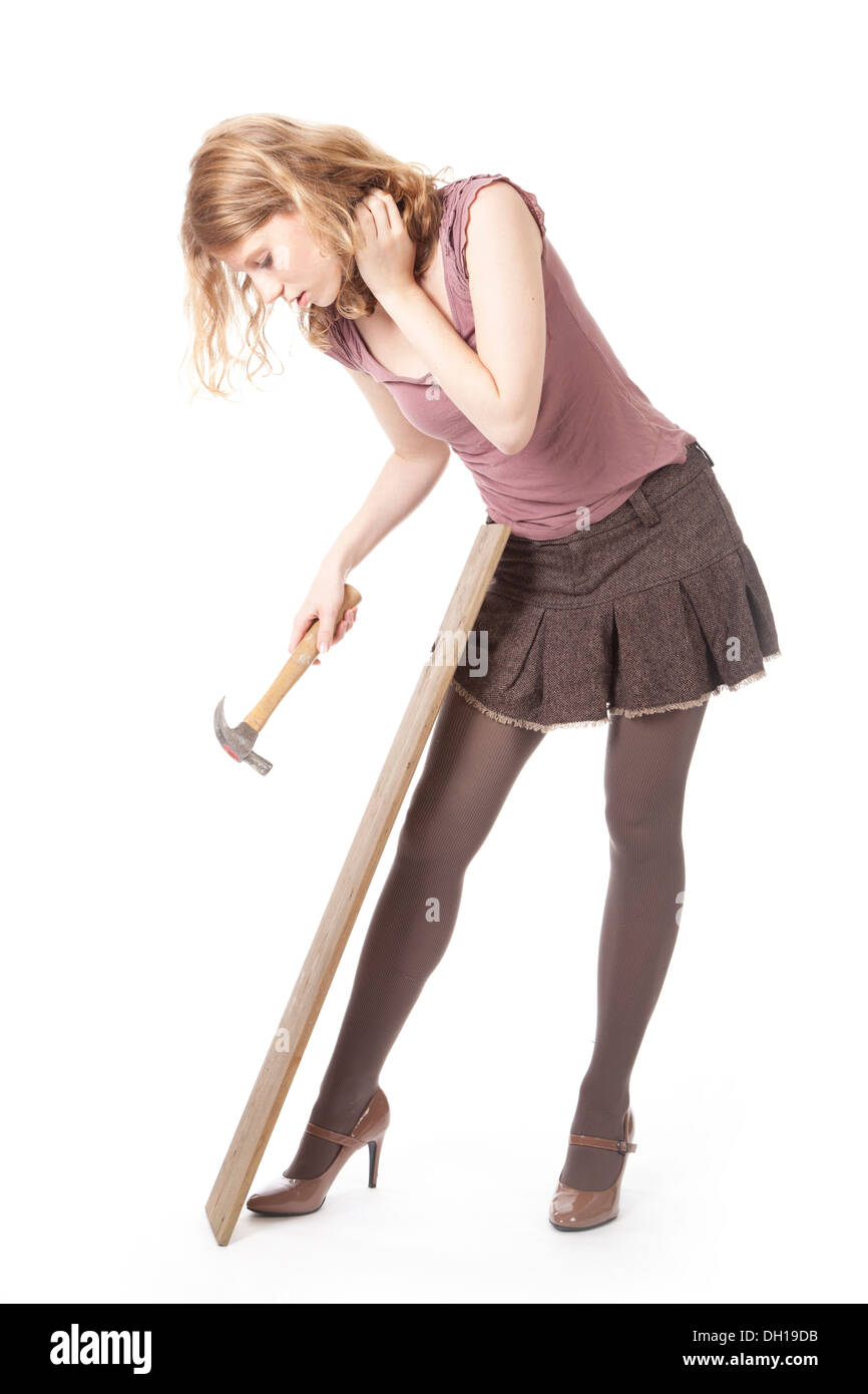 young pretty woman with hammer and wood against white background Stock ...