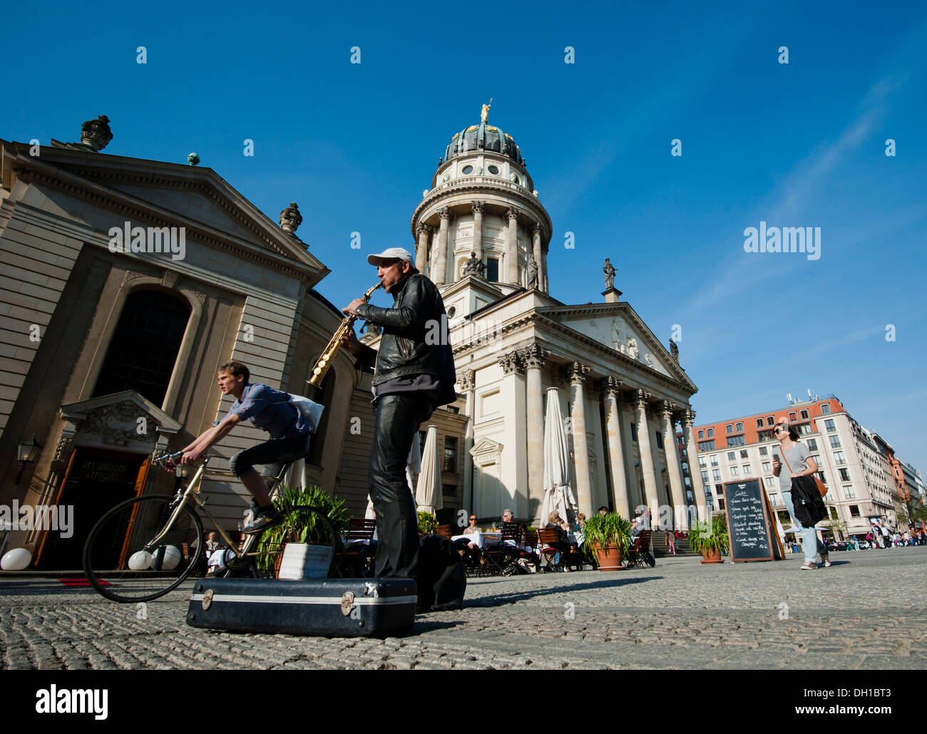 A musician plays music in a street scene in Berlin, Germany Stock Photo ...