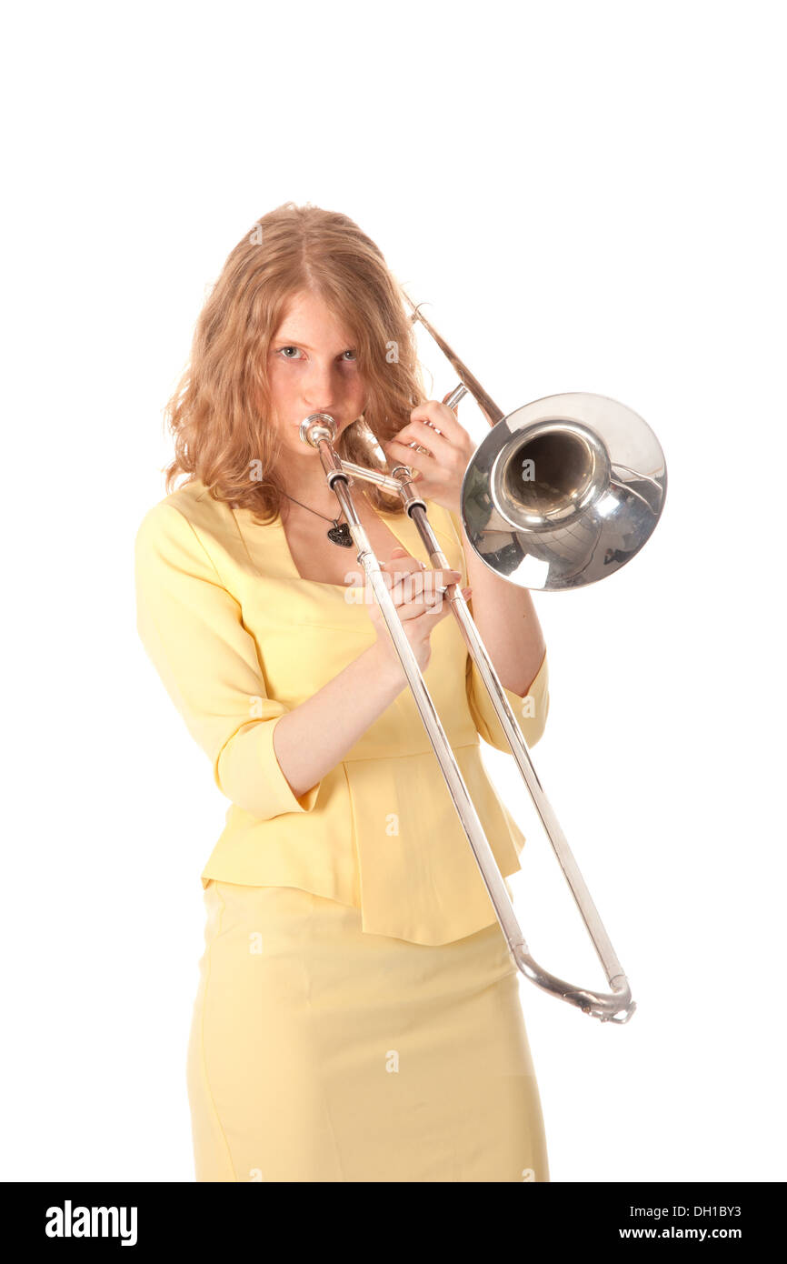 young woman in yellow holding trombone and white background Stock Photo ...