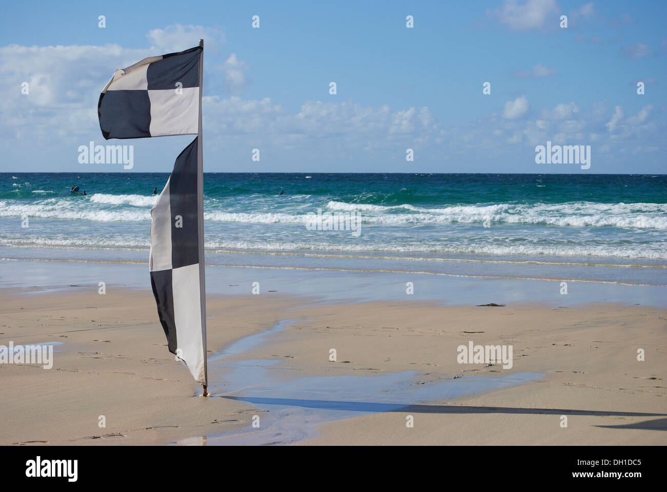 Flags on beach with surf Stock Photo - Alamy