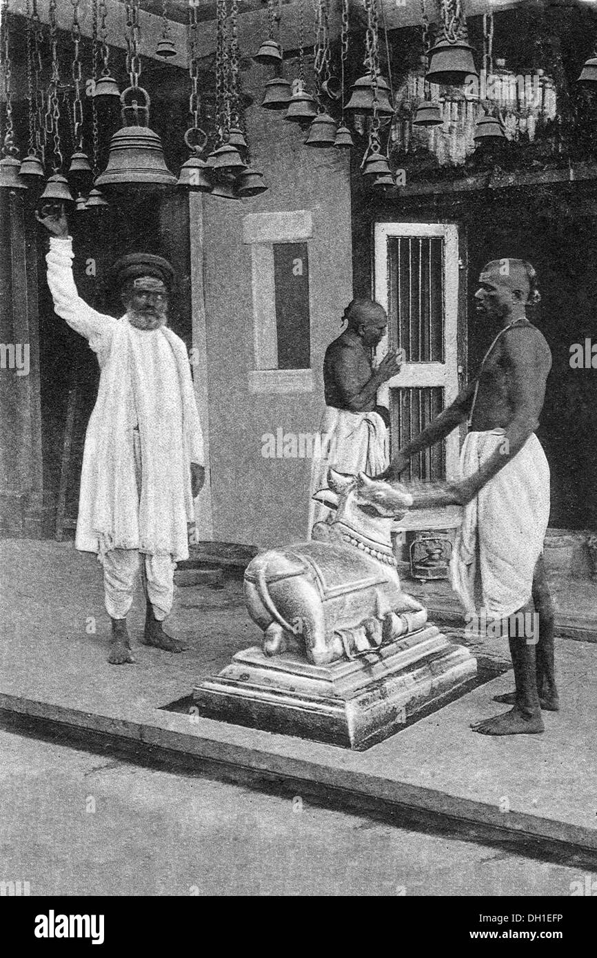 old vintage photo of man ringing bell in walkeshwar temple Mumbai ...