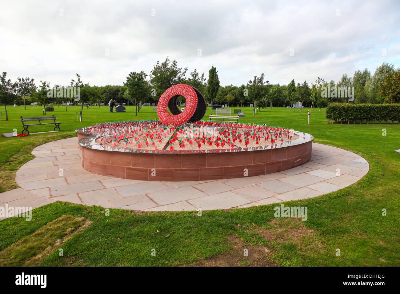 A poppy memorial built in the shape of a poppy with red poppies on it ...